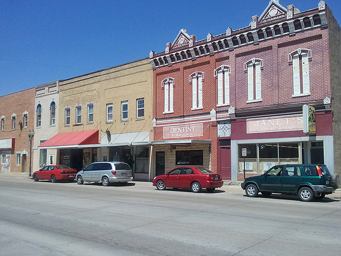 Crete's historic downtown buildings stand tall against moody skies, offering affordable living with a dash of collegiate culture.