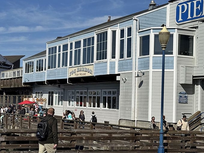 Fog Harbor's blue-trimmed entrance promises maritime delights. Like stepping onto a fancy boat, minus the seasickness and with better food options.