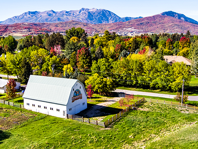 Huntsville's white barn stands proudly against Utah's dramatic mountain backdrop, like a painting come to life in this pastoral valley scene.