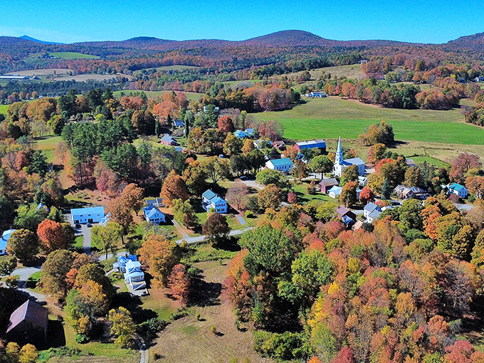 Peacham's aerial view showcases Vermont's fall splendor, where colorful trees surround a village that time politely decided to leave alone.
