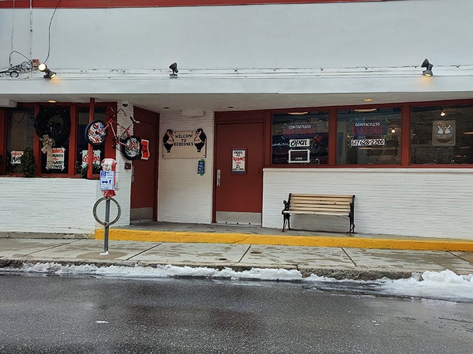 Redbones storefront: Snow-dusted sidewalk leads to this unassuming entrance - inside awaits the warm embrace of smoky, meaty salvation.