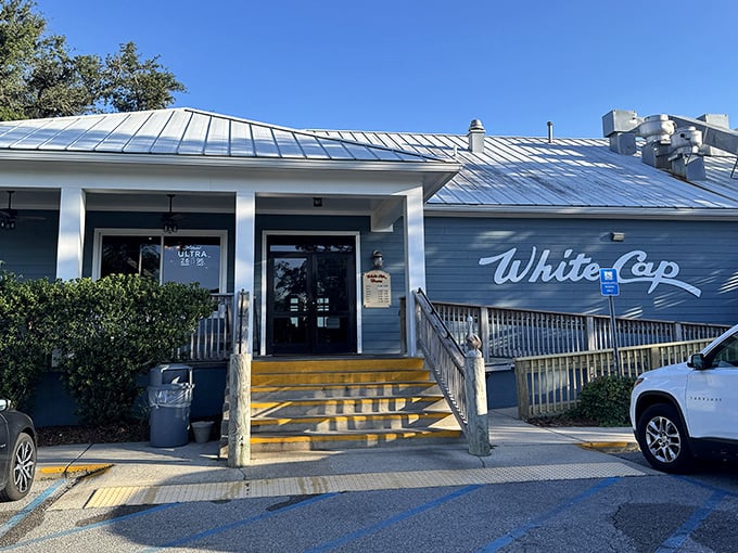 White Cap's blue-and-white exterior matches the Gulf waters it overlooks—nature's perfect color coordination for seafood heaven.