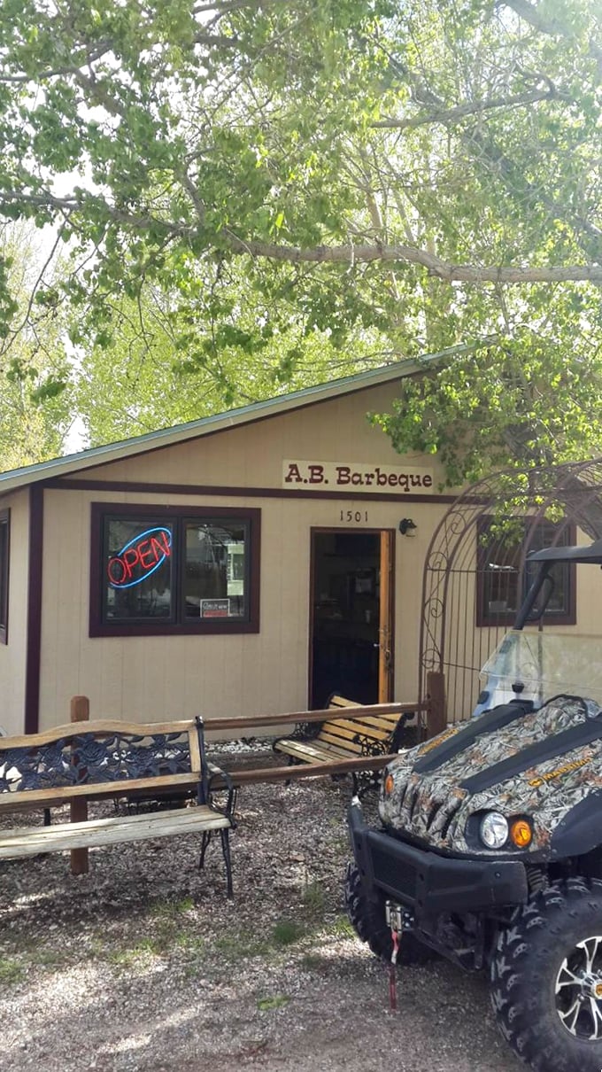 The simple wooden deck and welcoming entrance at AB BBQ invite you to slow down and savor the smoky goodness.