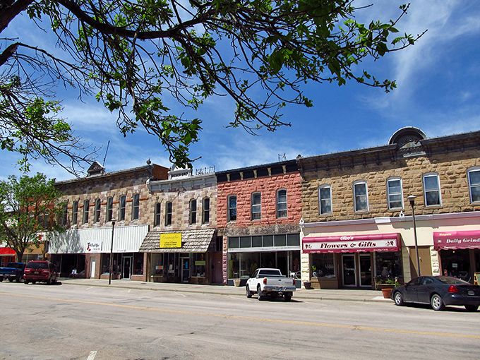 Tree-lined streets frame Chadron's historic storefronts, creating the perfect backdrop for your next Sandhills adventure.