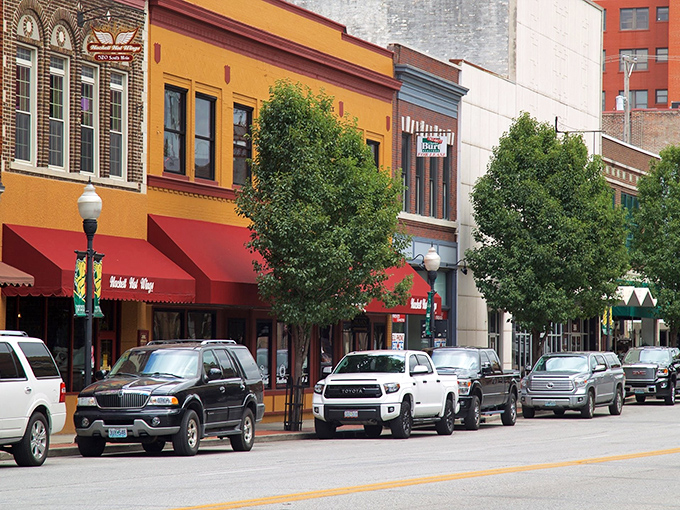 Colorful historic buildings line downtown Joplin's Main Street, where bright awnings welcome visitors to local shops.