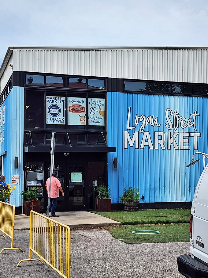 The bright blue exterior of Logan Street Market stands out in the neighborhood. A community hub disguised as a market.