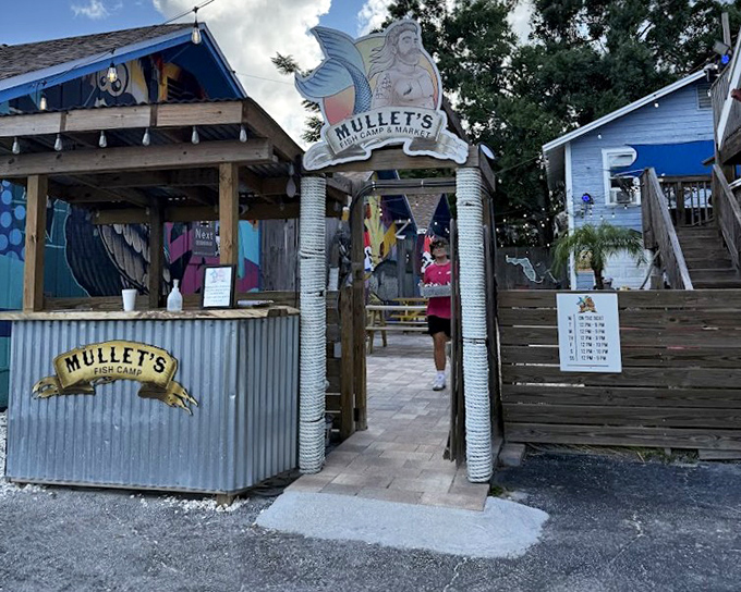 The whimsical entrance to Mullet's Fish Camp feels like stepping into a storybook where every meal has a happy ending.