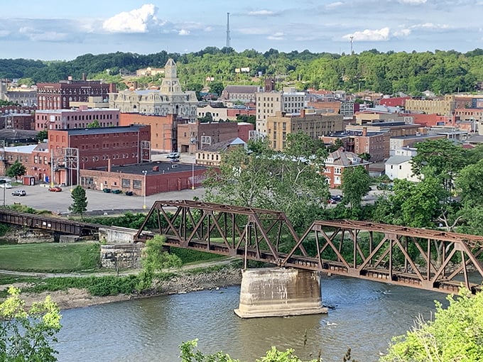 Historic Zanesville skyline with its iconic bridge spanning the Muskingum River under blue Ohio skies.