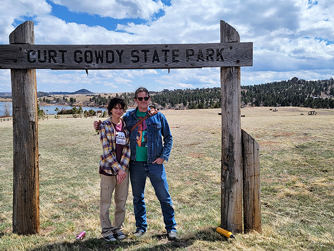 The wooden sign frames more than just visitors &ndash; it captures that moment when everyday worries dissolve into Wyoming's expansive landscape.