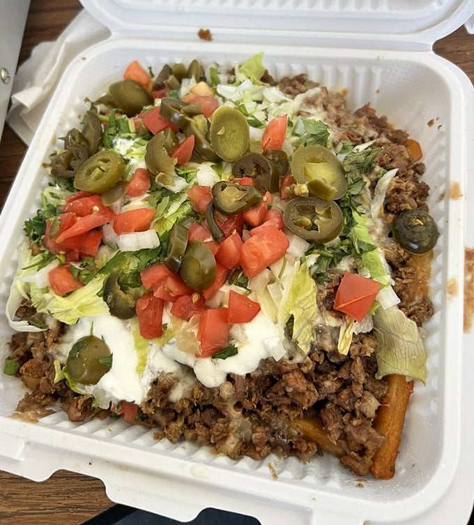 Asada fries loaded with meat, cheese, jalape&ntilde;os, and sour cream &ndash; a beautiful mess worth every napkin.
