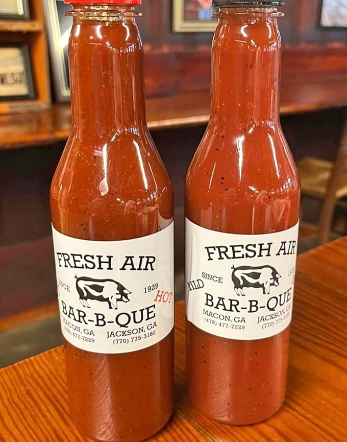Their sauce bottles stand like sentinels of flavor &ndash; one mild, one hot, both capable of making grown adults lick their fingers in public.