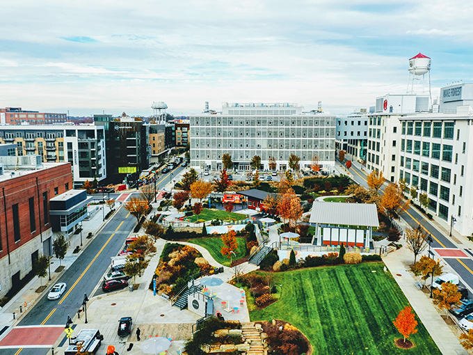 Fall colors transform this urban green space, where modern apartments surround a community gathering spot that hosts everything from yoga classes to outdoor concerts.