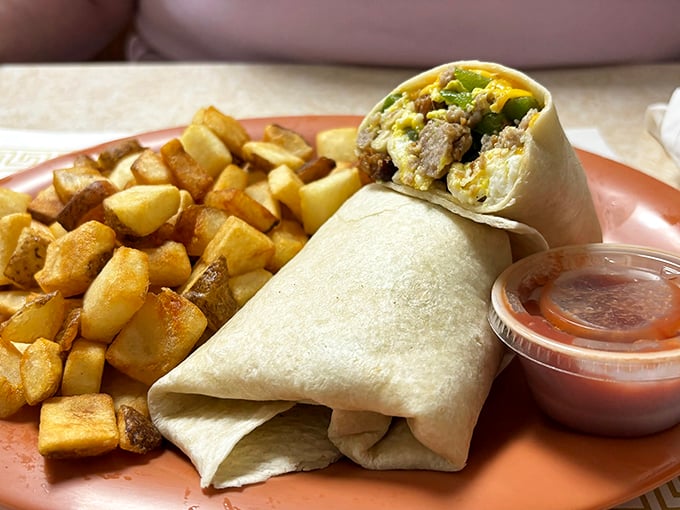 Breakfast burrito: the morning's most perfect portable feast. Golden potatoes and a side of salsa make this worth waking up for.