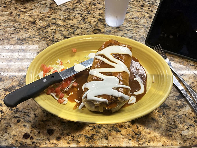 This burrito doesn't just satisfy hunger—it abolishes it. Wrapped in a tortilla and smothered in sauce, it's breakfast that requires both fork and commitment.