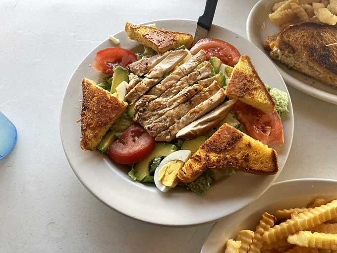 A salad at a diner? When it looks this good—crisp romaine, perfectly grilled chicken, and golden triangles of toast—even breakfast devotees might be tempted.