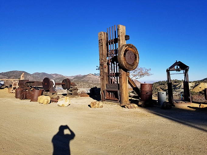 Mining equipment rests under brilliant blue skies, silent sentinels to the backbreaking work that built fortunes and shaped the West.