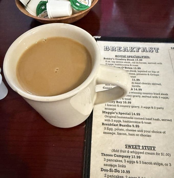 There's something poetic about a simple mug of diner coffee waiting beside a well-worn menu of breakfast classics.