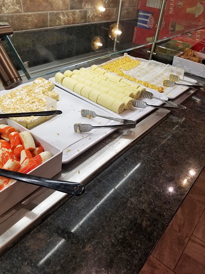 The dessert station features cream rolls and sweet treasures lined up like contestants in a beauty pageant where everyone's a winner—especially your sweet tooth.