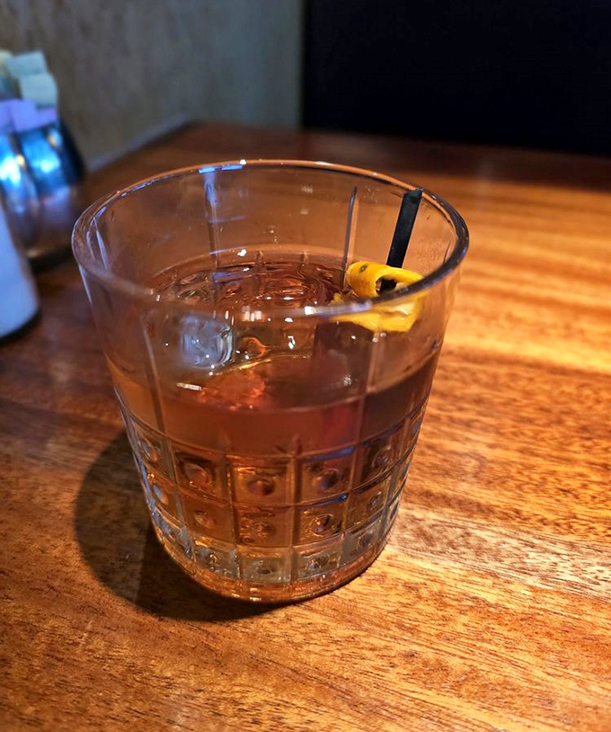 A perfectly crafted cocktail sits like liquid amber in cut crystal&mdash;the prelude to an evening of culinary delights.