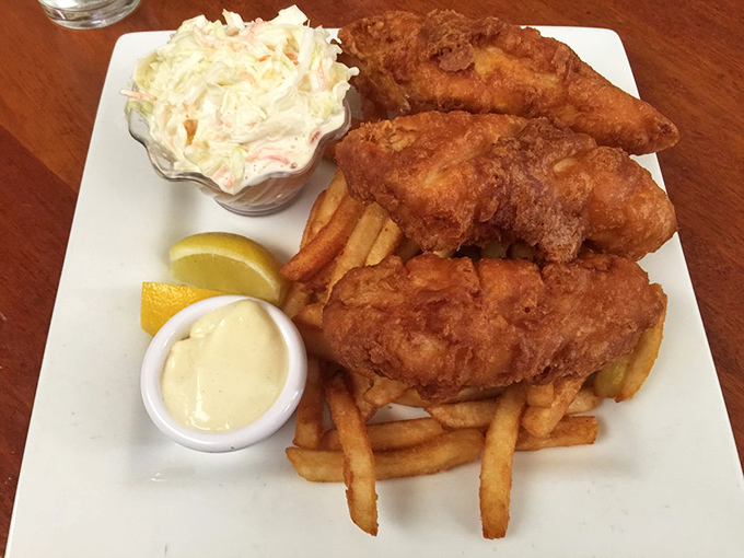 Fish and chips done right &ndash; golden, crispy batter protecting flaky white fish like armor, with fries standing by for dipping duty.