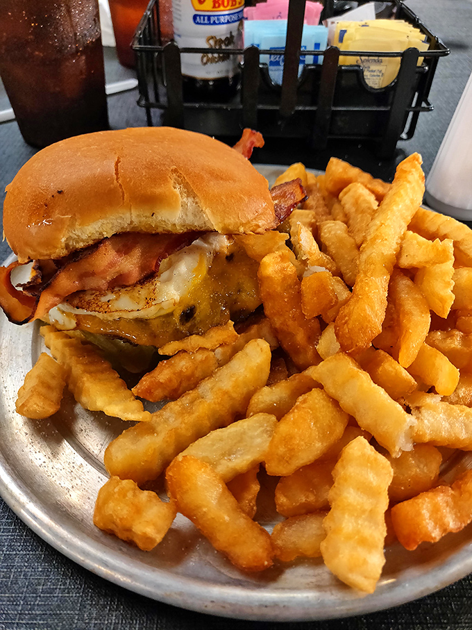 This isn't just a burger; it's an engineering marvel of beef, bacon, cheese and fries that requires both hands and zero shame.