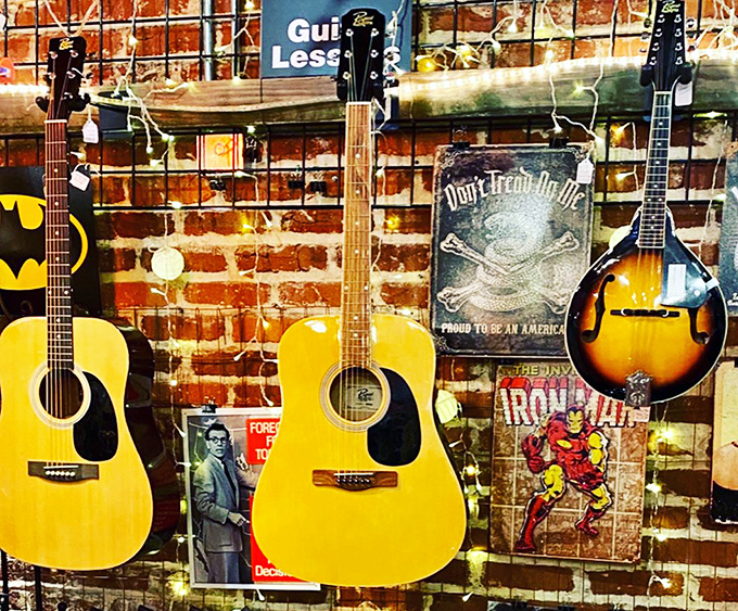 Acoustic dreams hanging on brick walls. These guitars aren't just instruments—they're stories waiting for new fingers to continue their melodies.