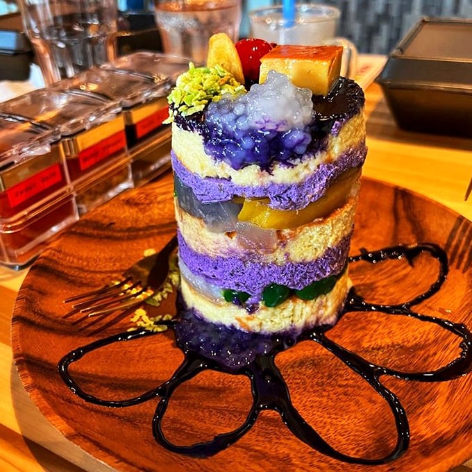 This isn't just dessert &ndash; it's an edible purple skyscraper of joy where every colorful layer tells a different sweet story.