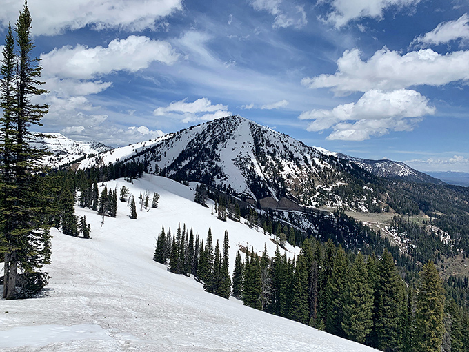 Snow-dusted peaks meet endless sky in this winter wonderland where silence speaks louder than any city ever could.