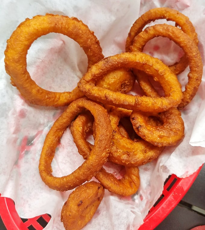 Onion rings that achieve the impossible: perfectly crisp exteriors giving way to sweet, tender onion within. The holy grail of fried foods.
