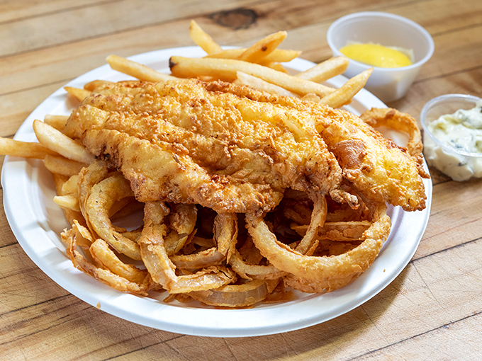 Fish so perfectly fried it makes you wonder if Neptune himself is back there working the fryer, with onion rings that deserve their own fan club.