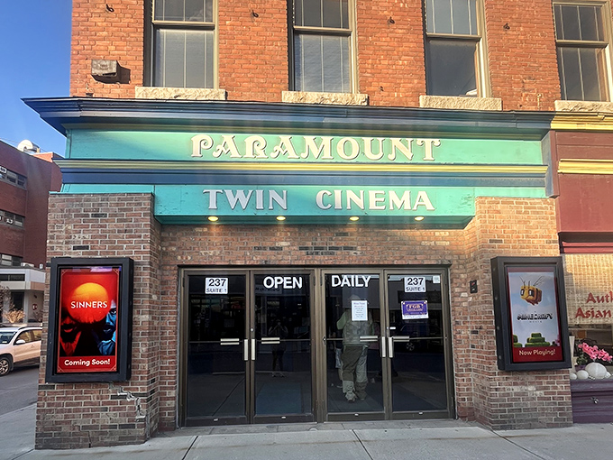 The Paramount Theatre's turquoise marquee brightens downtown, promising entertainment without big-city ticket prices or parking nightmares.