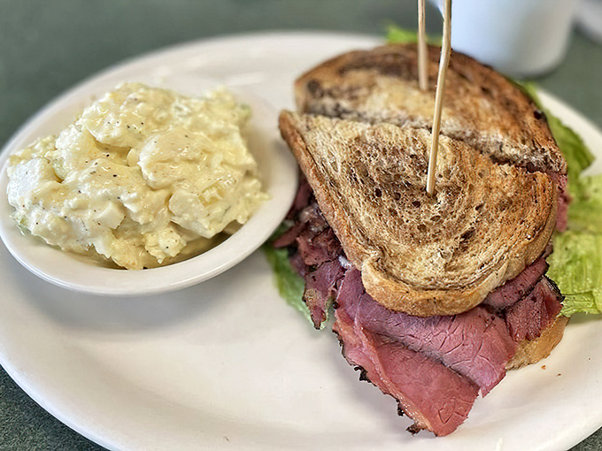 This pastrami sandwich isn't messing around – it's thick-cut, perfectly seasoned, and paired with potato salad that deserves equal billing.