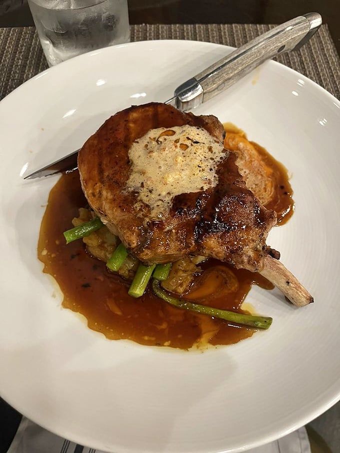 This pork chop isn't just cooked&mdash;it's been sweet-talked to perfection atop a bed of vegetables.