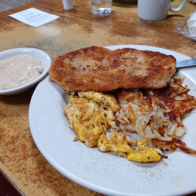 A plate that says "Montana" louder than words &ndash; golden hashbrowns, scrambled eggs, and a pork steak that means business.