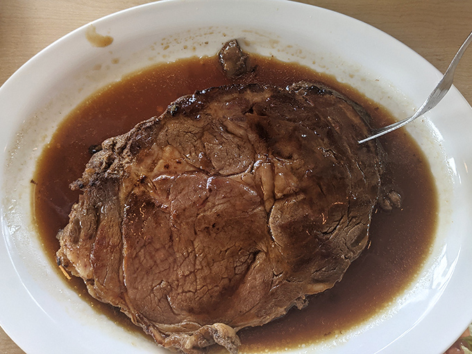 Prime rib swimming in its natural habitat of savory au jus. This isn't just meat&mdash;it's a commitment to carnivorous excellence.
