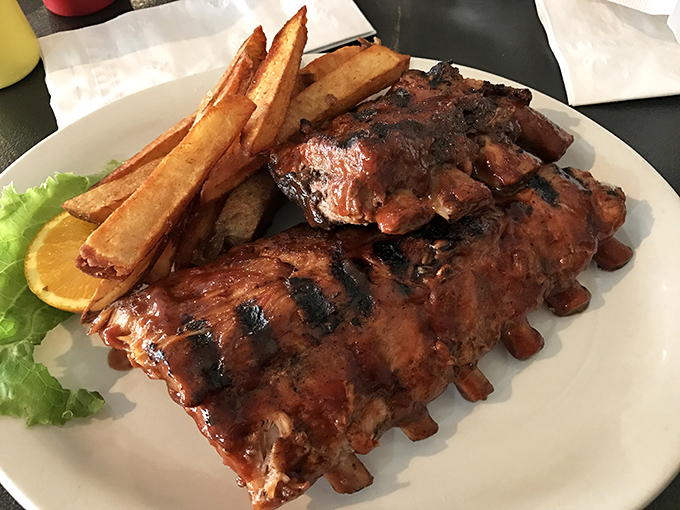 Ribs so tender they practically leap off the bone, glistening with a sauce that should be bottled and sold as Montana's finest export.