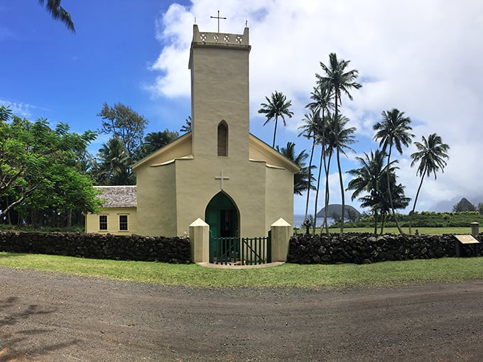 Saint Philomena's Church stands as a serene sentinel amid palm trees, its simple architecture belying the complex history it witnessed.