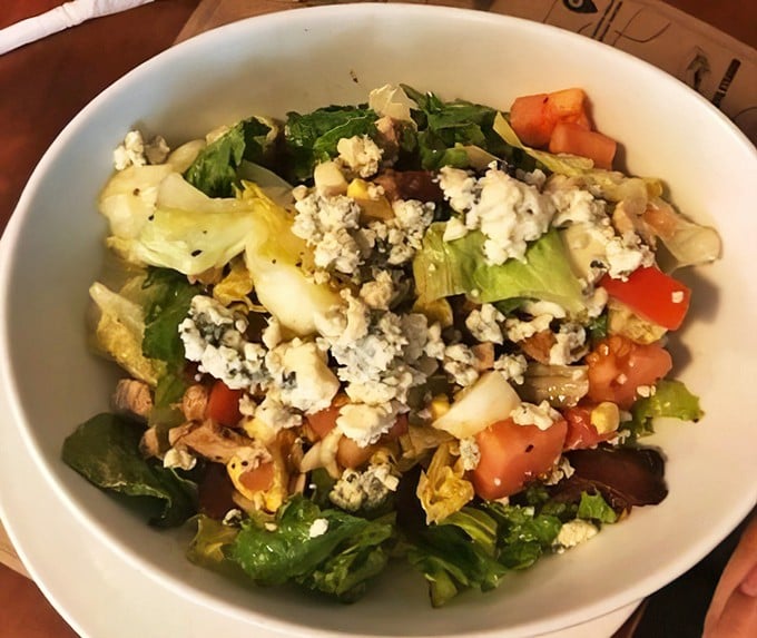 Even the salads here mean business—fresh greens, vibrant tomatoes, and crumbled cheese create a lighter option that doesn't sacrifice an ounce of flavor.