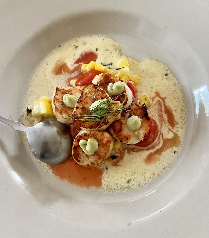 These scallops aren't just seared, they're transformed – golden brown outside, perfectly tender inside, swimming in a sauce worth bottling.