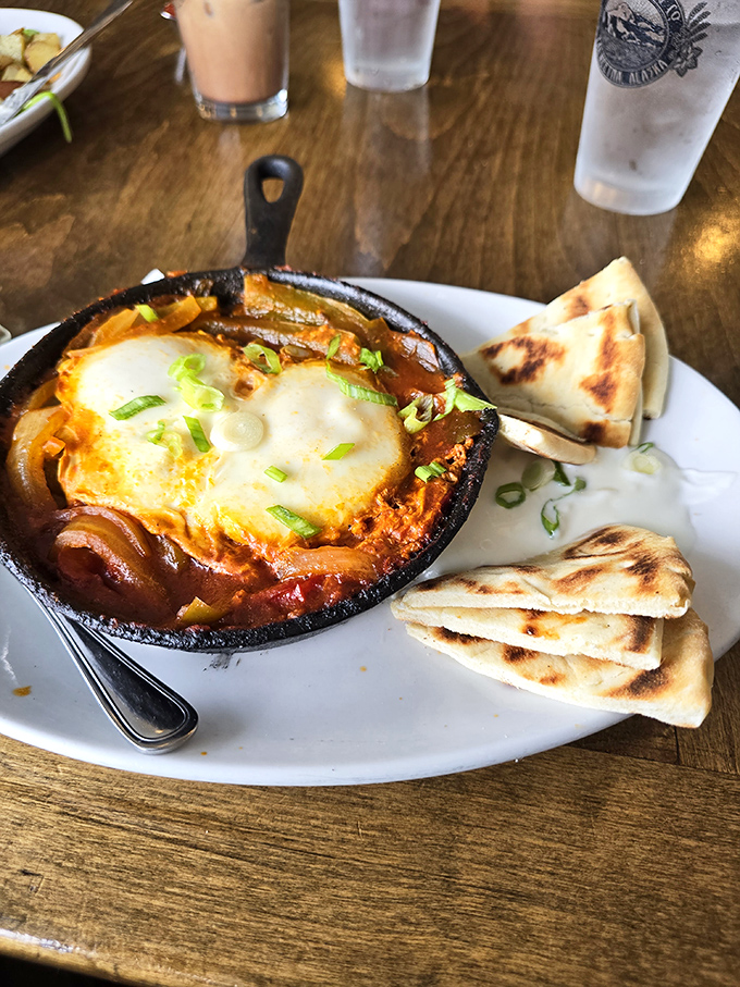 Shakshuka that traveled all the way from the Middle East to Alaska&mdash;eggs poached in a bubbling tomato sea, with pita triangles ready for dipping duty.