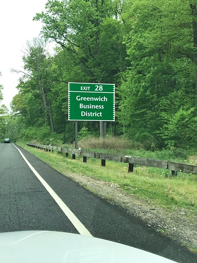 Exit signs nestled among greenery&mdash;because even directions deserve a proper setting on America's most picturesque commute.