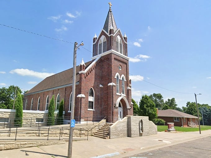 Gothic architecture reaches skyward at St. Edward Catholic Parish, where stained glass windows filter sunlight into rainbow patterns across wooden pews.