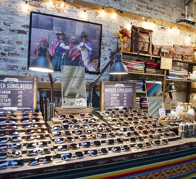 Wooden sunglasses displayed like museum artifacts. Because in Brooklyn, even your eye protection should have an artisanal backstory.