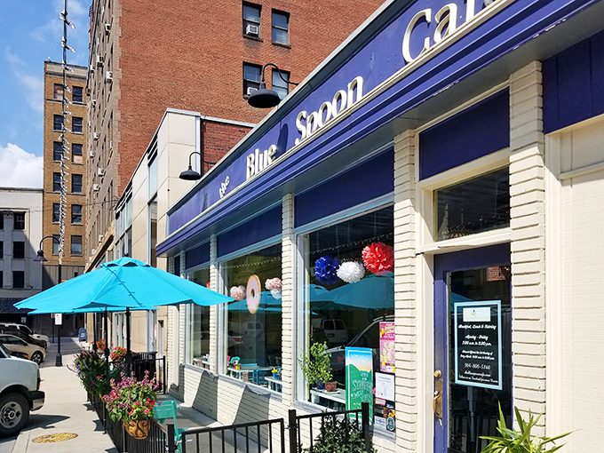 The Blue Spoon Cafe's cheerful awnings and outdoor seating beckon passersby to slow down, sip something refreshing, and watch the world go by at mountain pace.