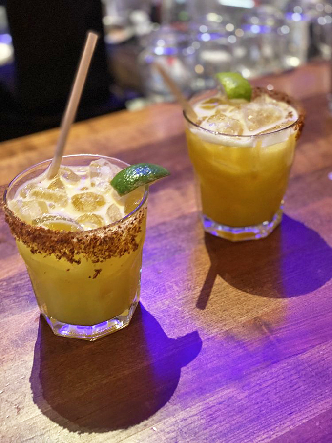 These aren't just margaritas - they're liquid sunshine with a spiced rim, the perfect companion to cut through rich pizza flavors.