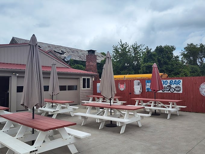 Vaughan's Pub & Grill's outdoor seating area awaits the evening crowd, where picnic tables and umbrellas promise conversations that outlast the sunset.