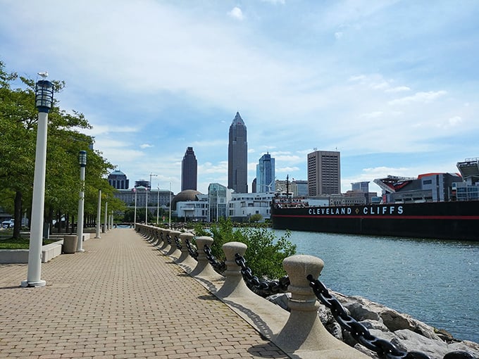 The downtown waterfront promenade offers stunning skyline views, with the historic ore boat Cleveland Cliffs adding industrial character to the scene.