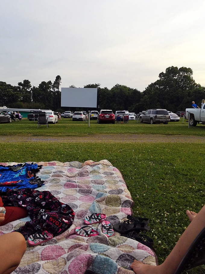 The perfect drive-in setup: a handmade quilt, flip-flops kicked off, and an unobstructed view of Hollywood magic in rural Arkansas.