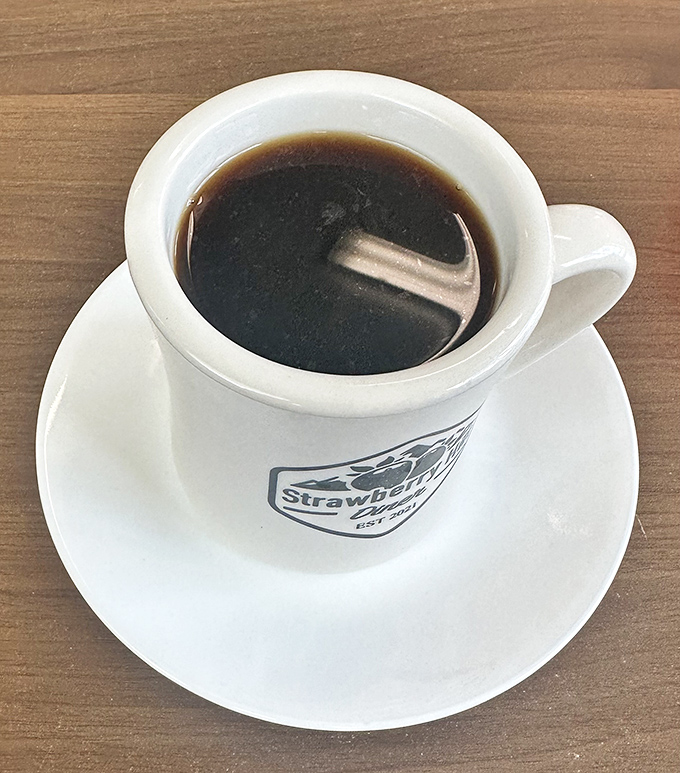 Coffee served in a mug that means business – the kind that keeps truckers alert and tourists lingering over second cups.