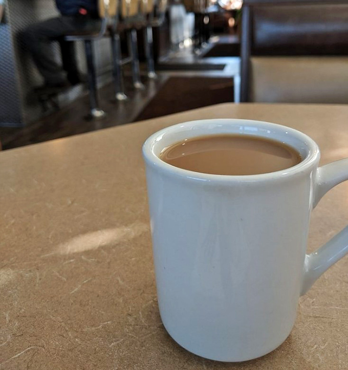 The humble white mug &ndash; vessel of liquid motivation and keeper of diner secrets. This coffee has probably heard more local news than the town paper.
